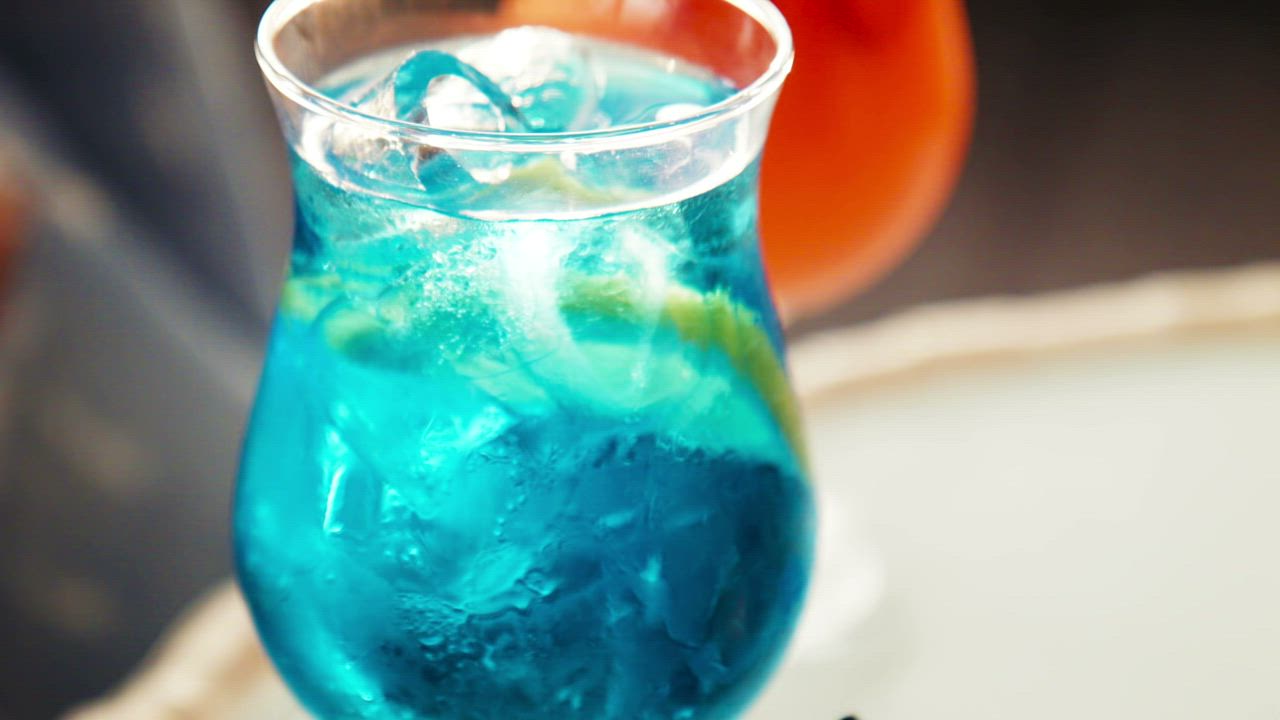 Tropical blue beverage with a fruit slice - Free Stock Video
