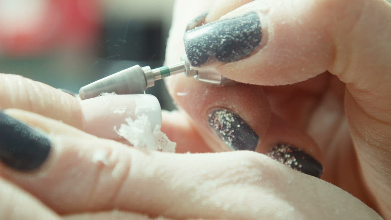 Working on nails with a mechanical tool - Free Stock Video