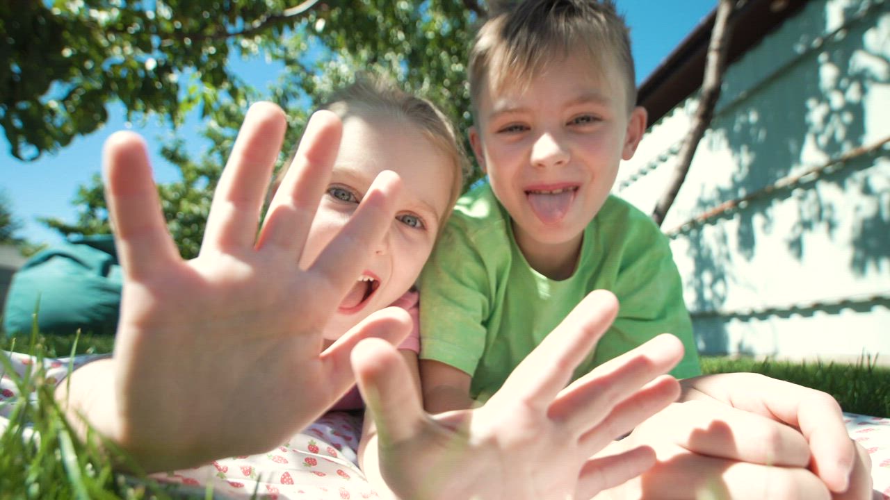 kids grimacing in the garden - Free Stock Video