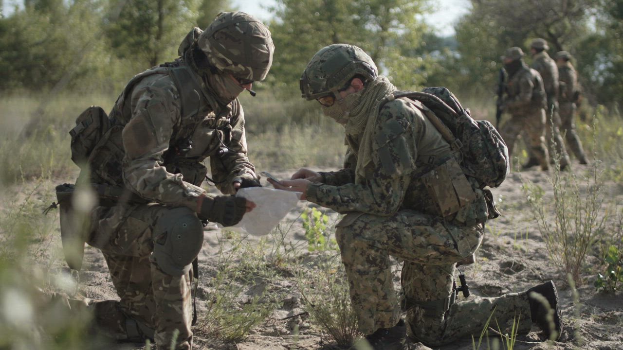 Military man check in the strategy on the map - Free Stock Video
