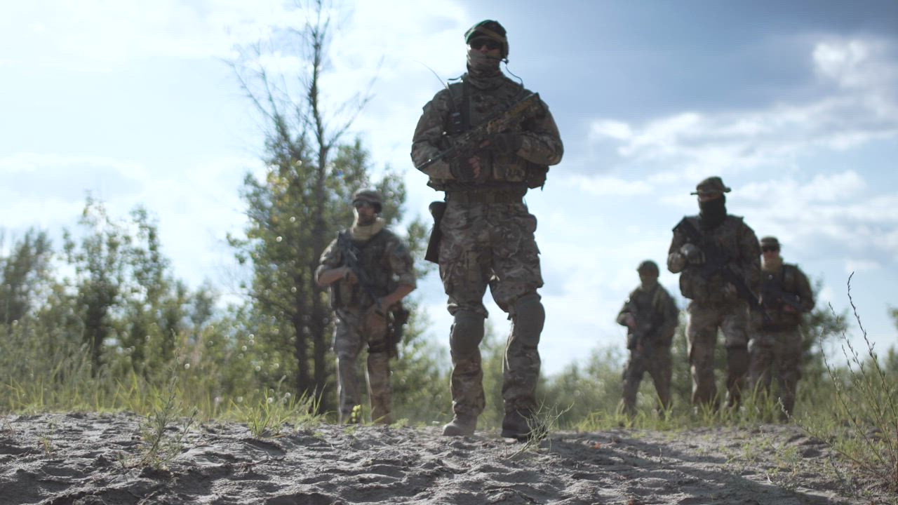 Group of soldiers walking in the battlefield - Free Stock Video