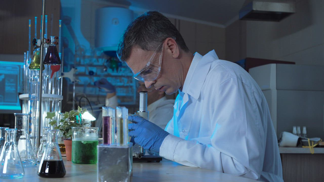 Scientist working with a microscope in the lab - Free Stock Video