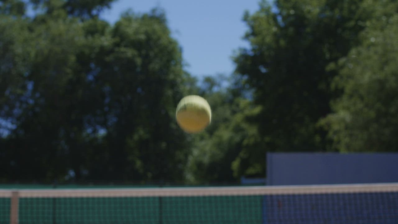 Tennis ball flying over the net - Free Stock Video