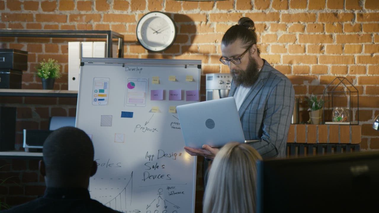 Man explaining charts to a small audience - Free Stock Video