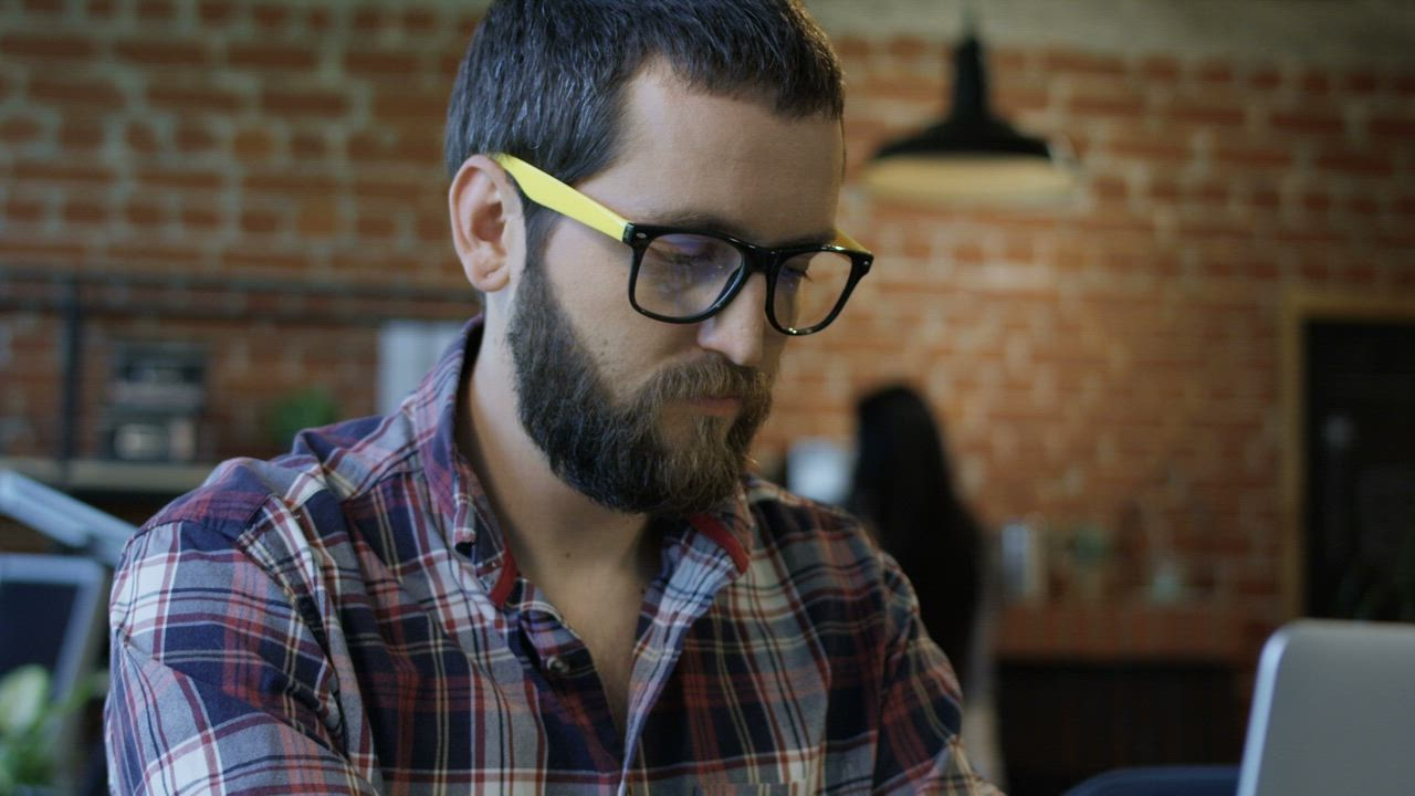 A young man thinking in front of the computer - Free Stock Video