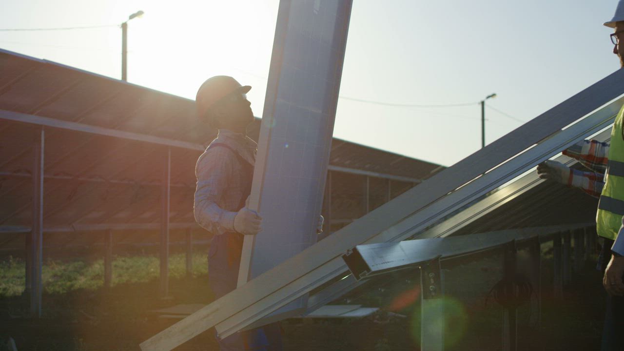 Installing a solar panel in the field - Free Stock Video