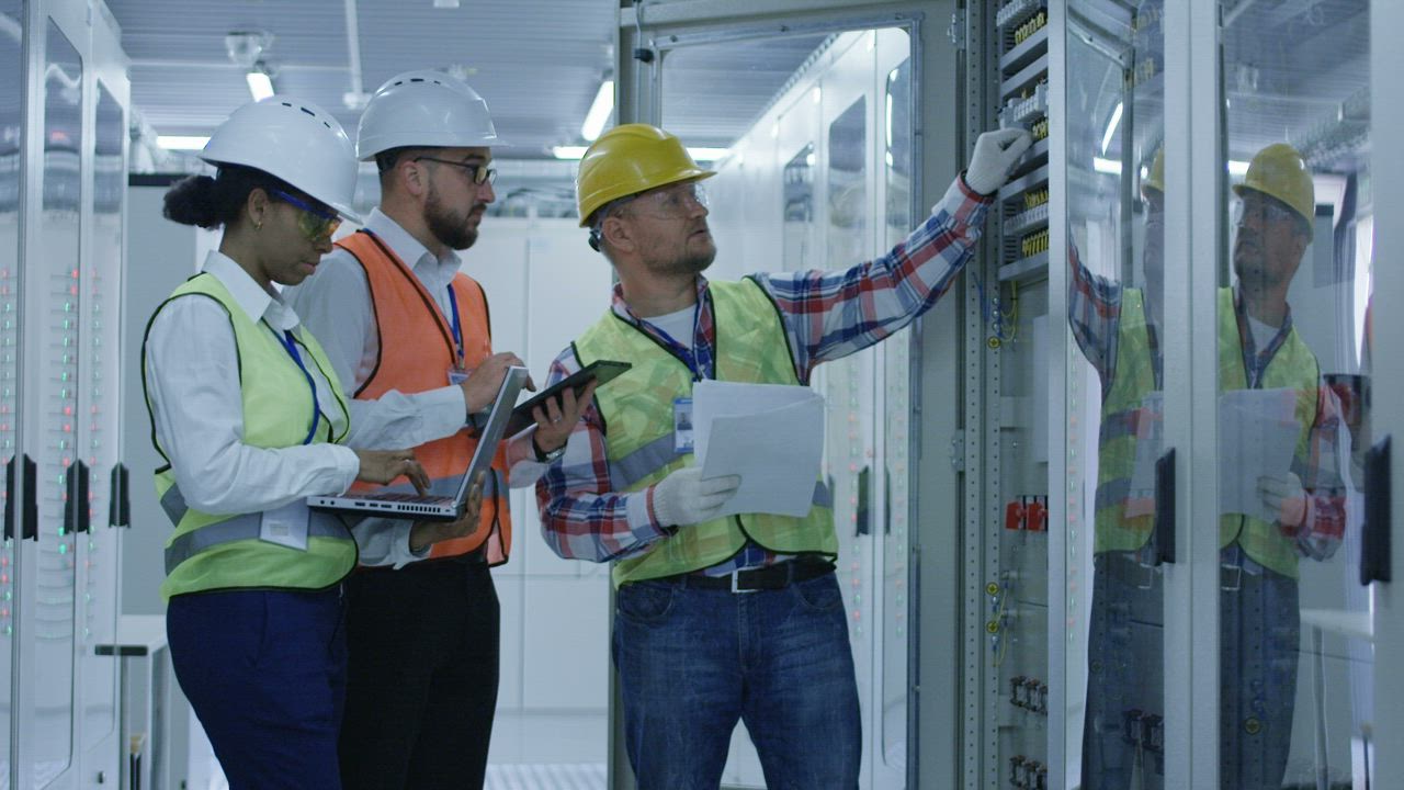 Engineers checking equipment data - Free Stock Video
