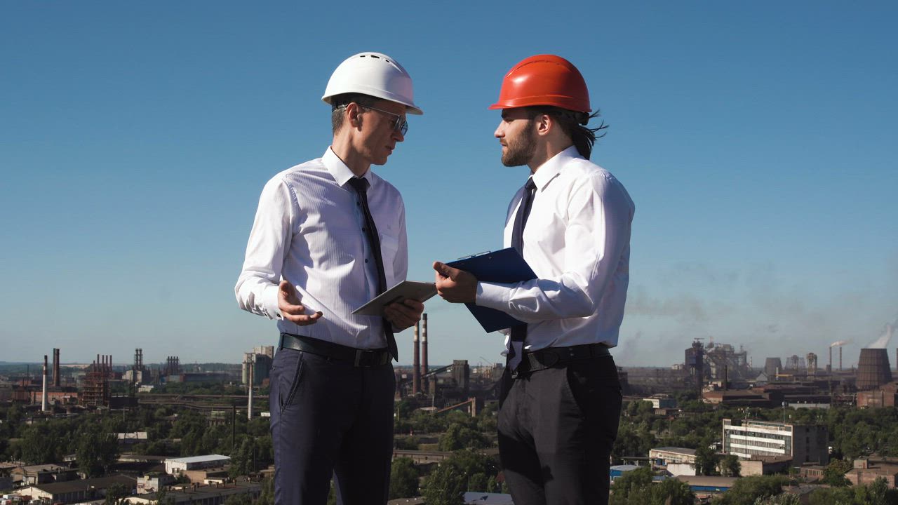 Engineers discussing project outdoors - Free Stock Video