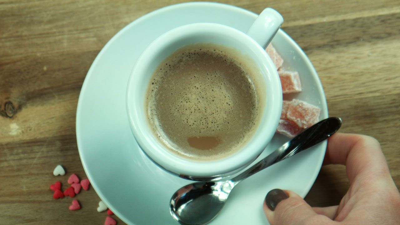 Hand puts a cup of coffee on the table - Free Stock Video