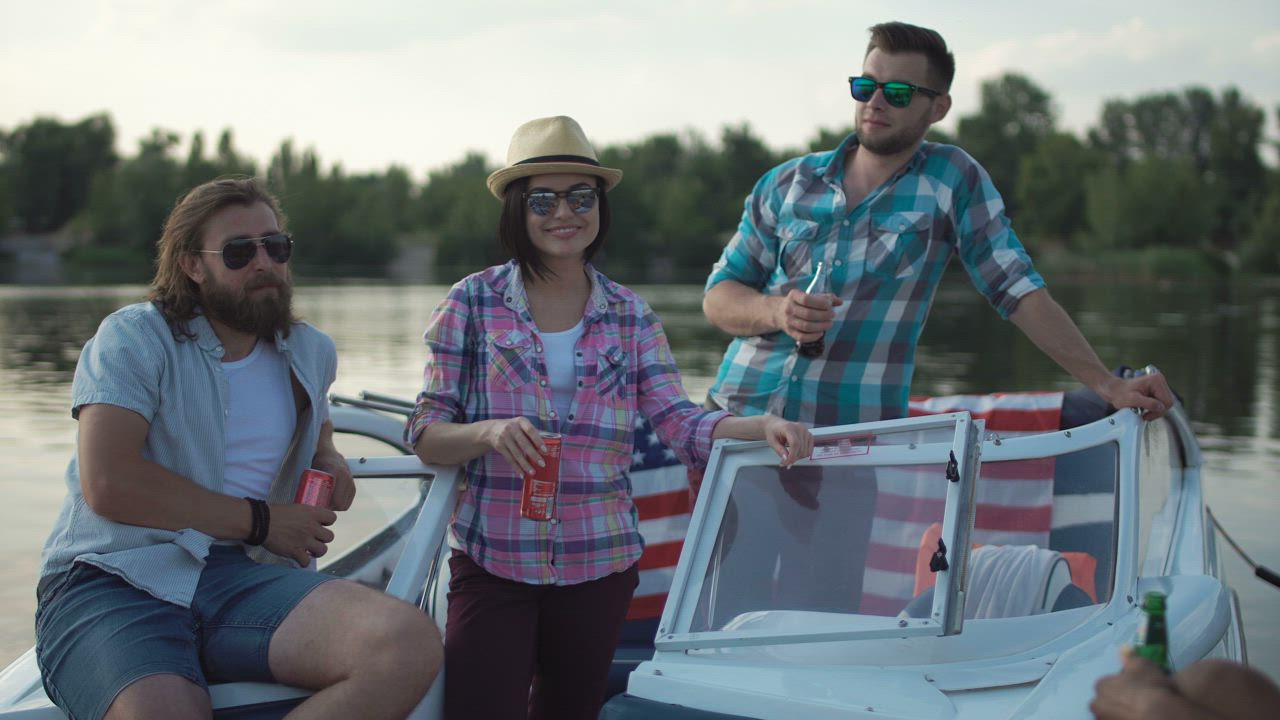 Friends chilling and drinking on a speedboat - Free Stock Video