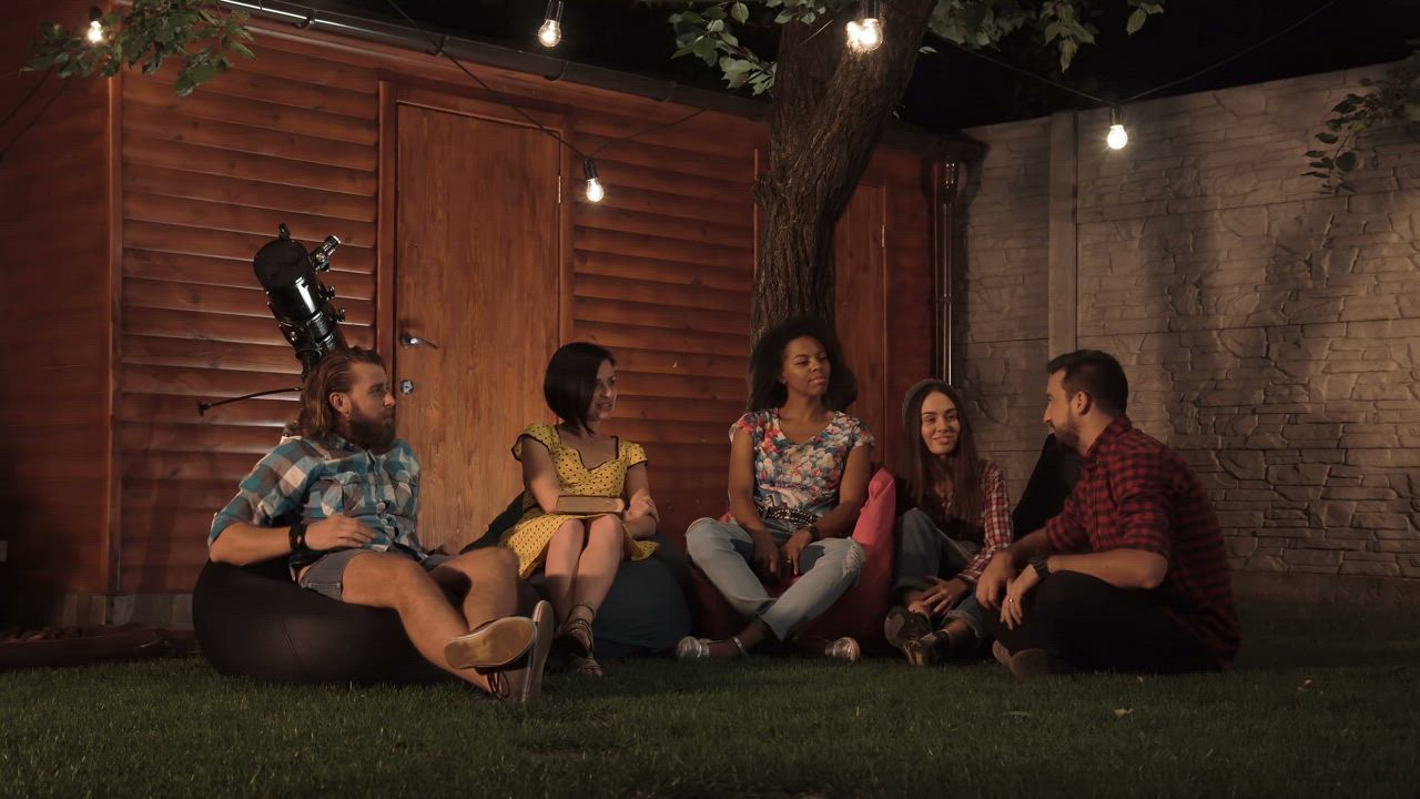 Friends chilling and talking in the backyard - Free Stock Video
