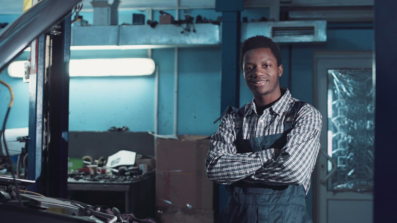 A young mechanic posing for the camera - Free Stock Video