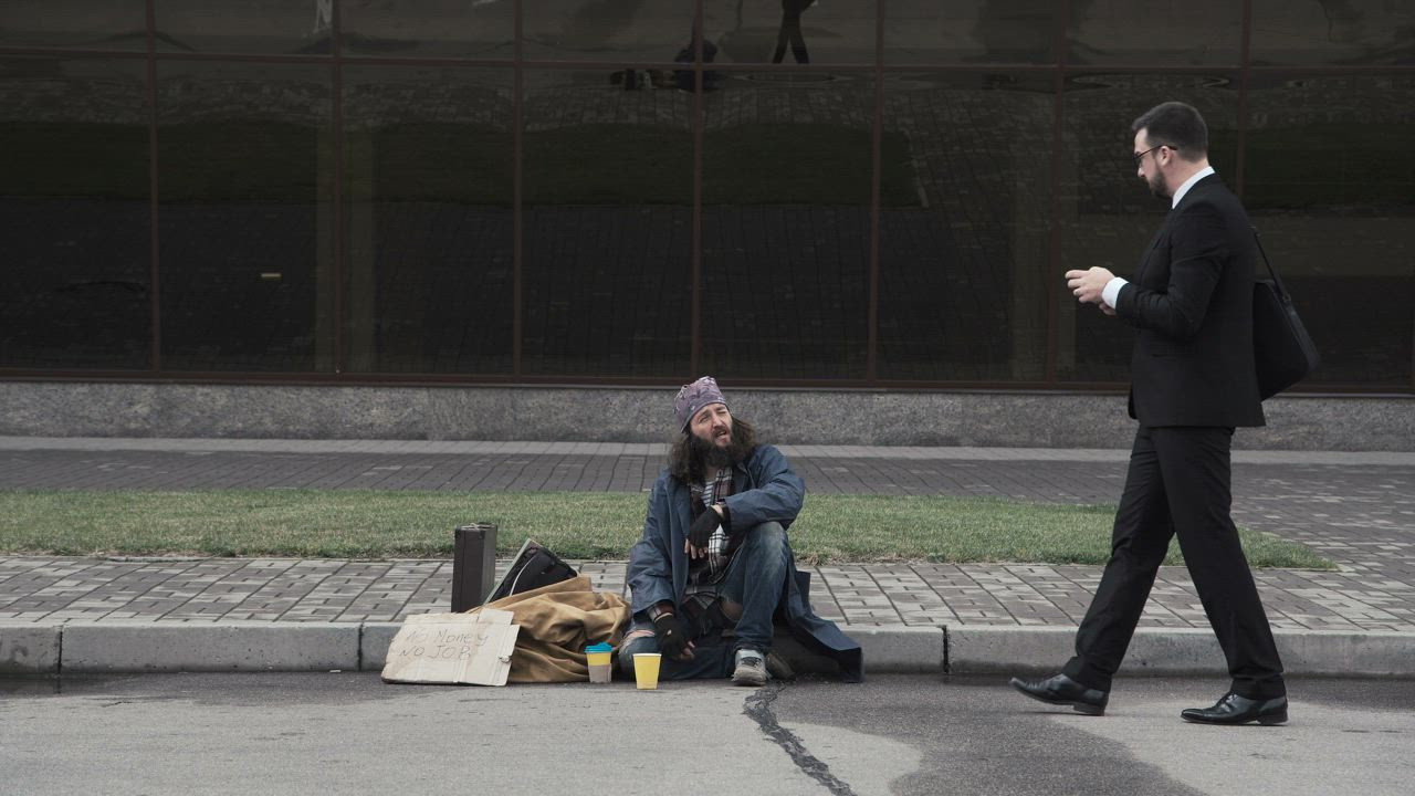 Businessman offers a job to homeless man - Free Stock Video