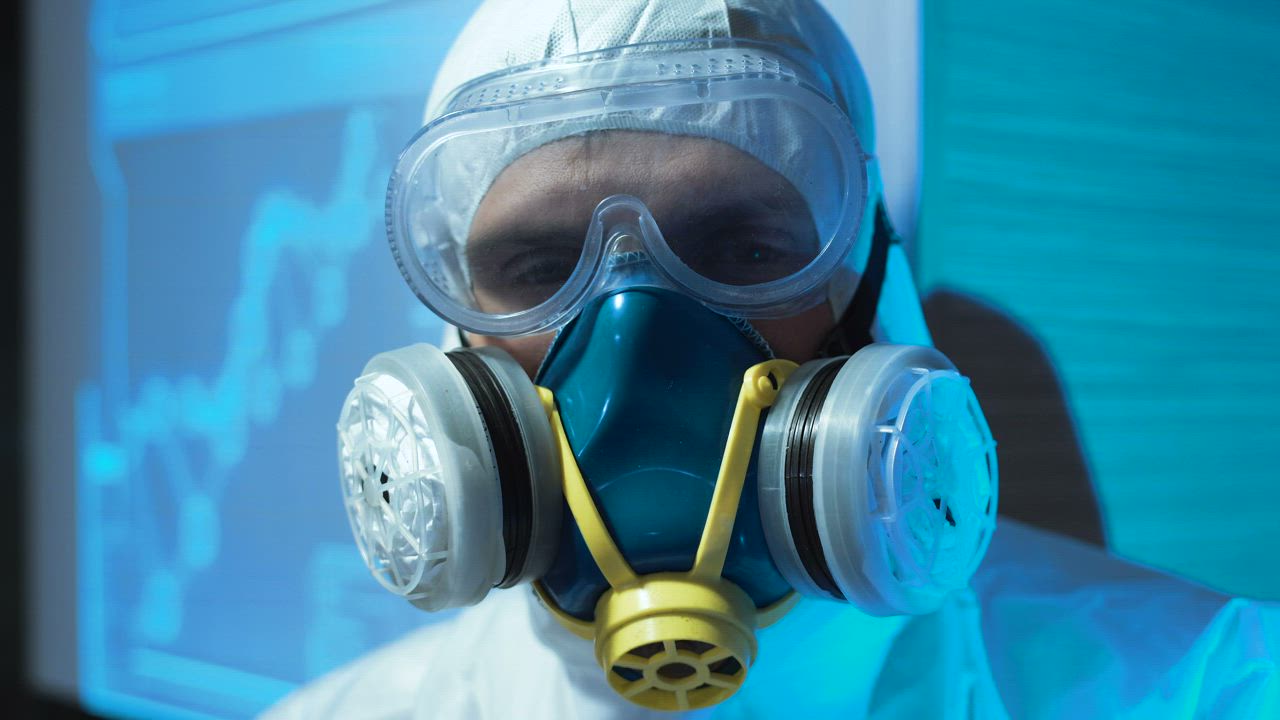 A man wearing a biohazard suit and a mask - Free Stock Video