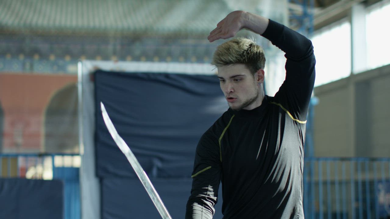 An athlete training with a sword - Free Stock Video
