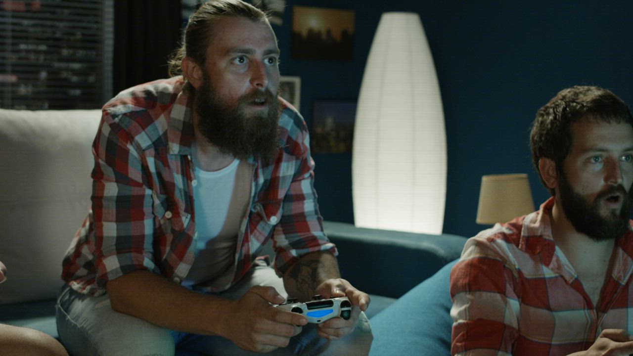 Men playing video games in the living room - Free Stock Video