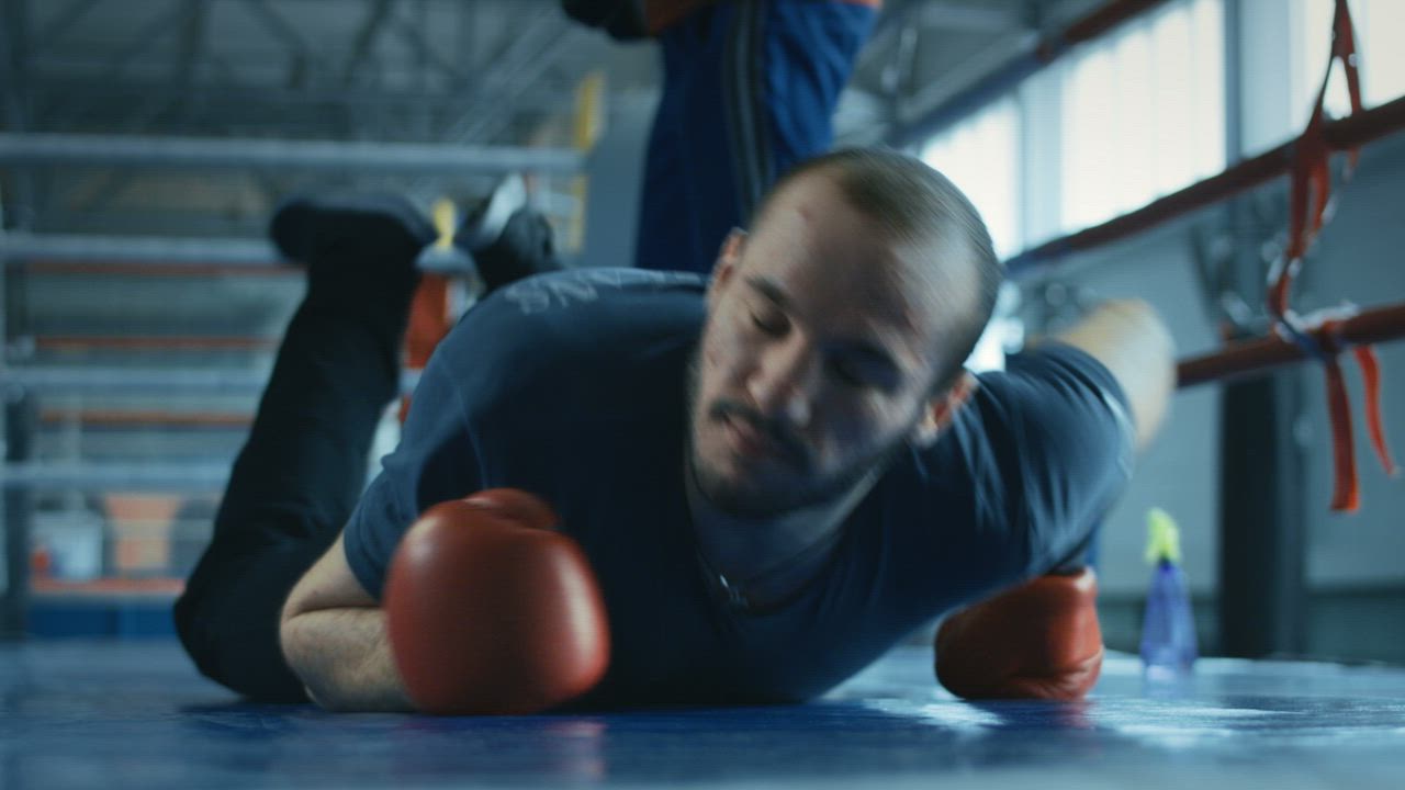 Knocked out boxer falls into the ring - Free Stock Video