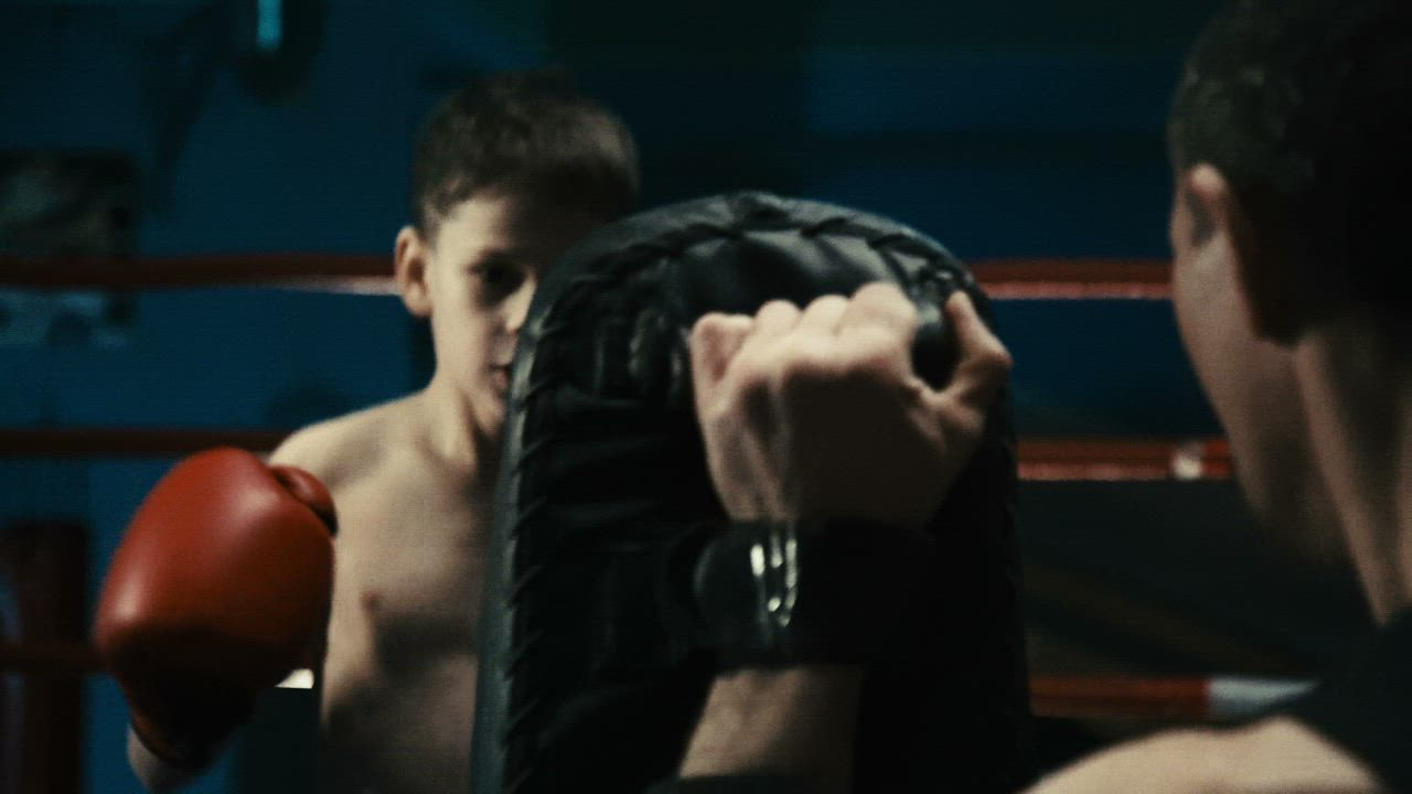 A little kid training boxing on the ring - Free Stock Video