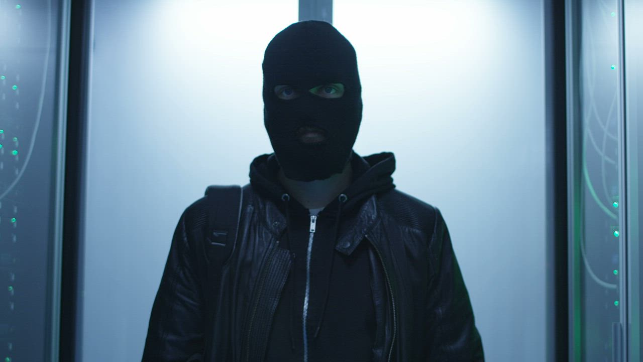 Hacker with face mask entering data center - Free Stock Video