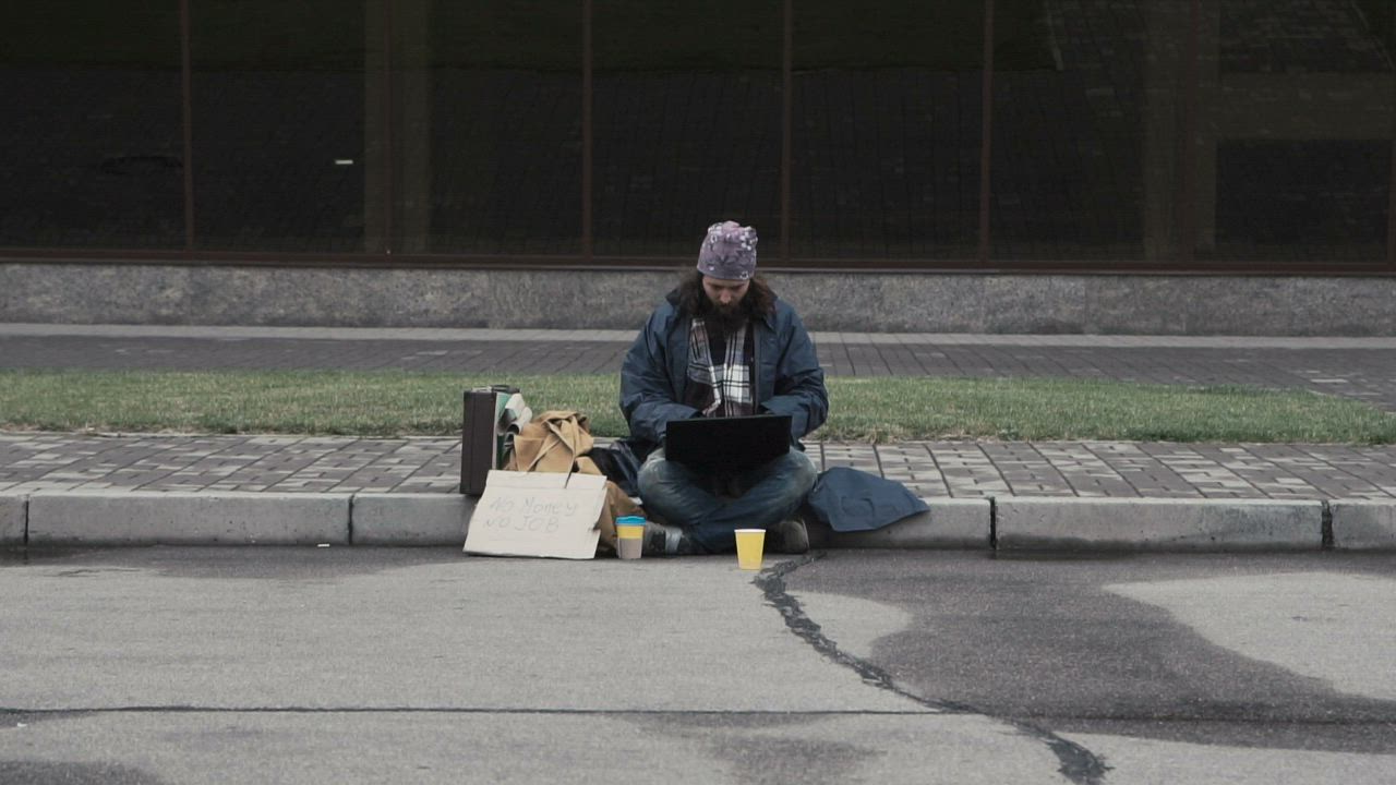 Excited homeless man with laptop - Free Stock Video