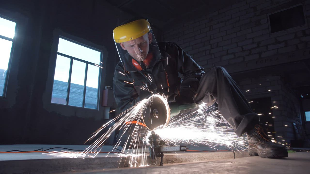 A man cutting metal with machine - Free Stock Video