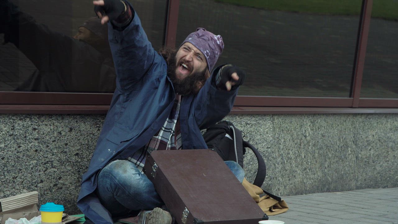 Excited happy homeless is drumming on a briefcase - Free Stock Video