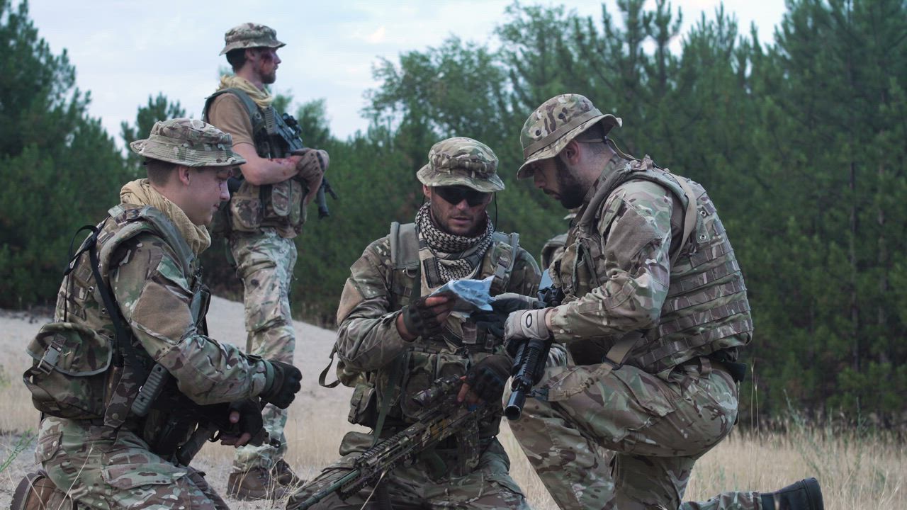 Soldiers checking the strategy on the map - Free Stock Video