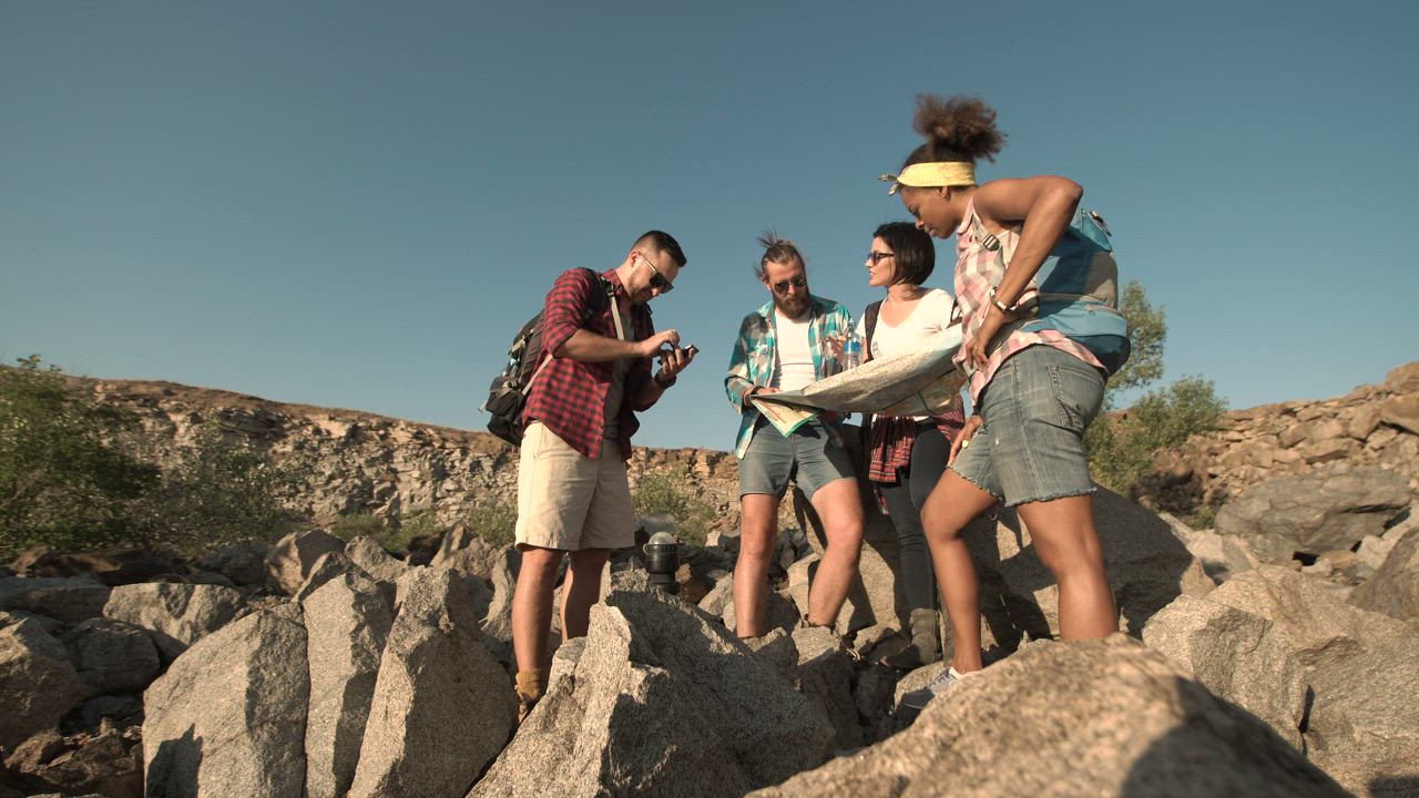 Travelers looking at map in the countryside - Free Stock Video