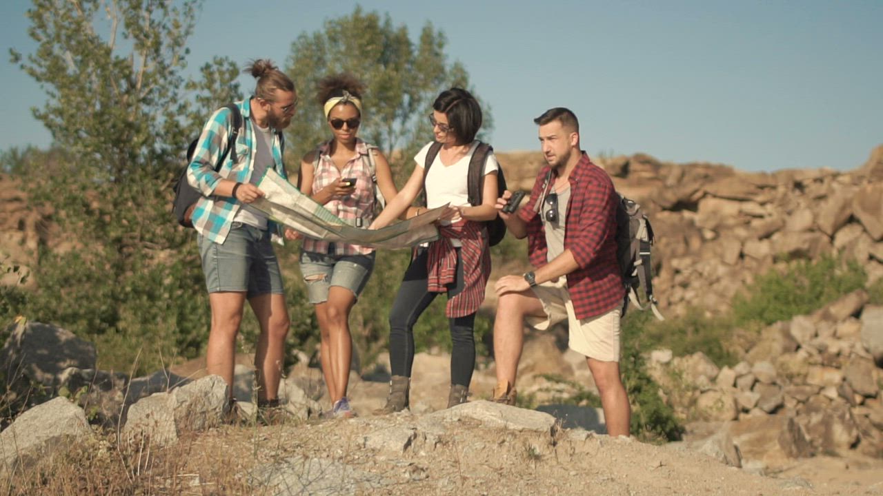 Travelers watching the map in the wild - Free Stock Video