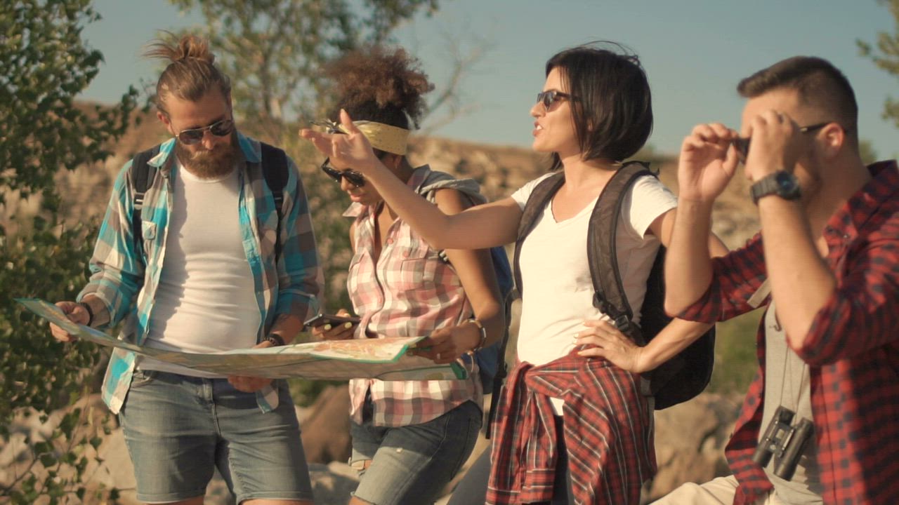 Travelers looking at the map in the wilderness - Free Stock Video