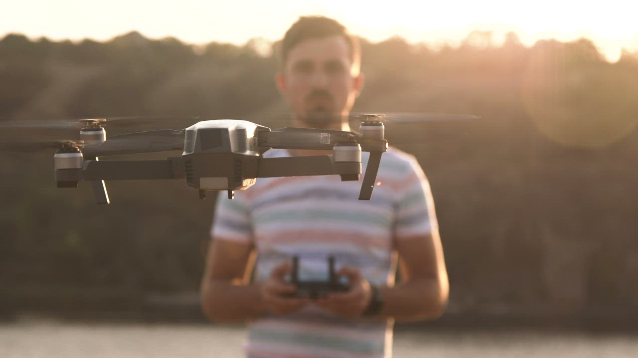 Man controlling drone with with remote controller - Free Stock Video