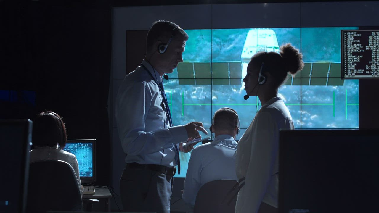 Having a conversation in space control center - Free Stock Video