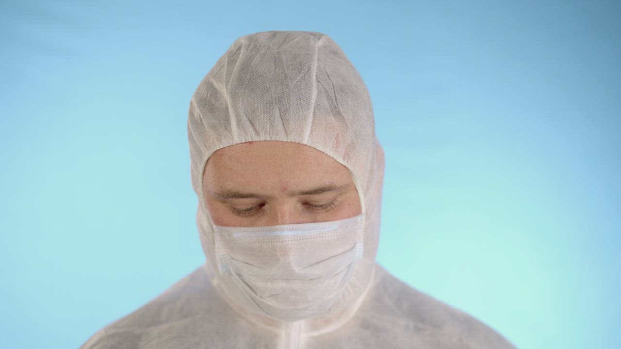 Man wearing full PPE while holding a vial - Free Stock Video