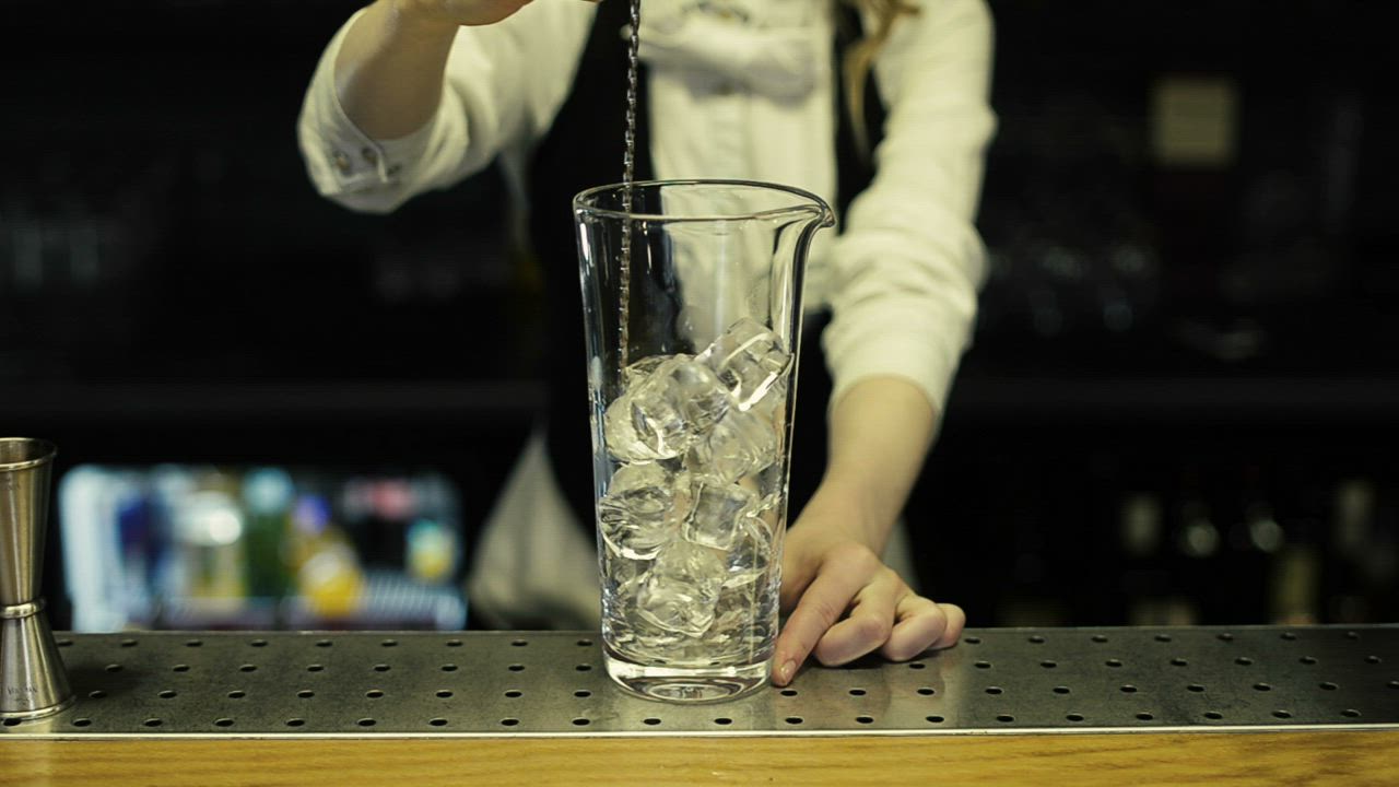 Mixing ice in a cocktail glass - Free Stock Video