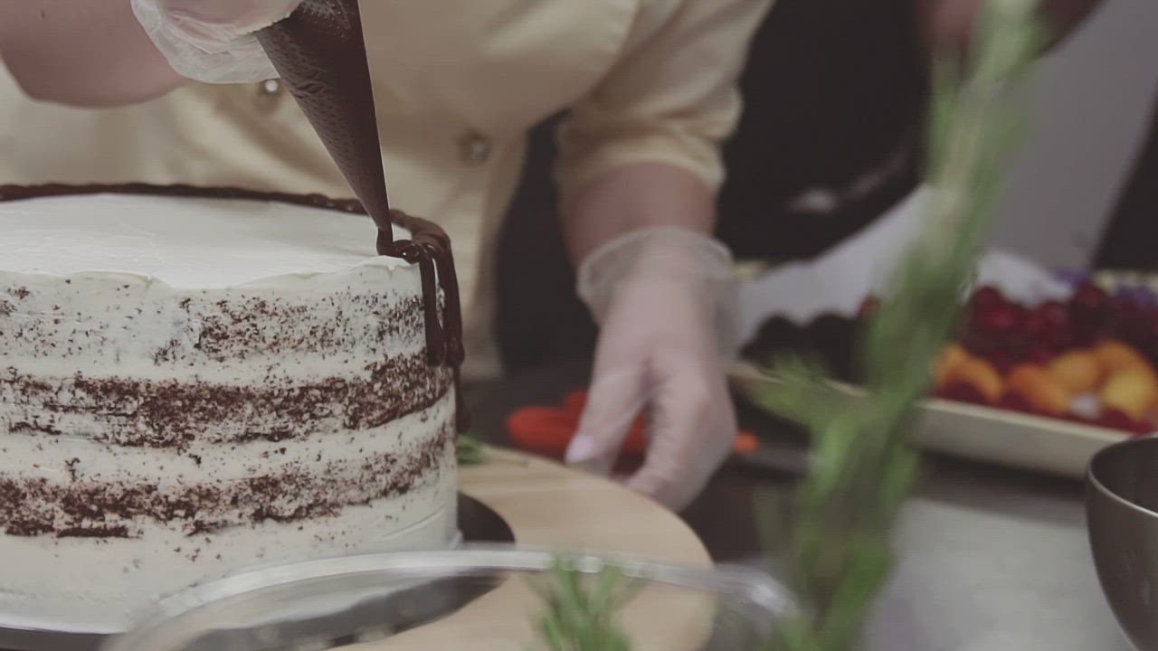 Decorating a cake with chocolate - Free Stock Video
