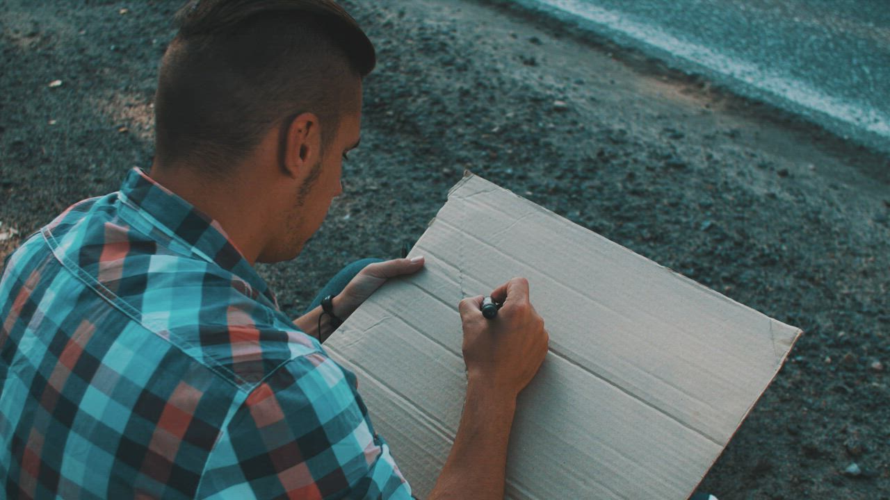 Writing on a cardboard sign - Free Stock Video