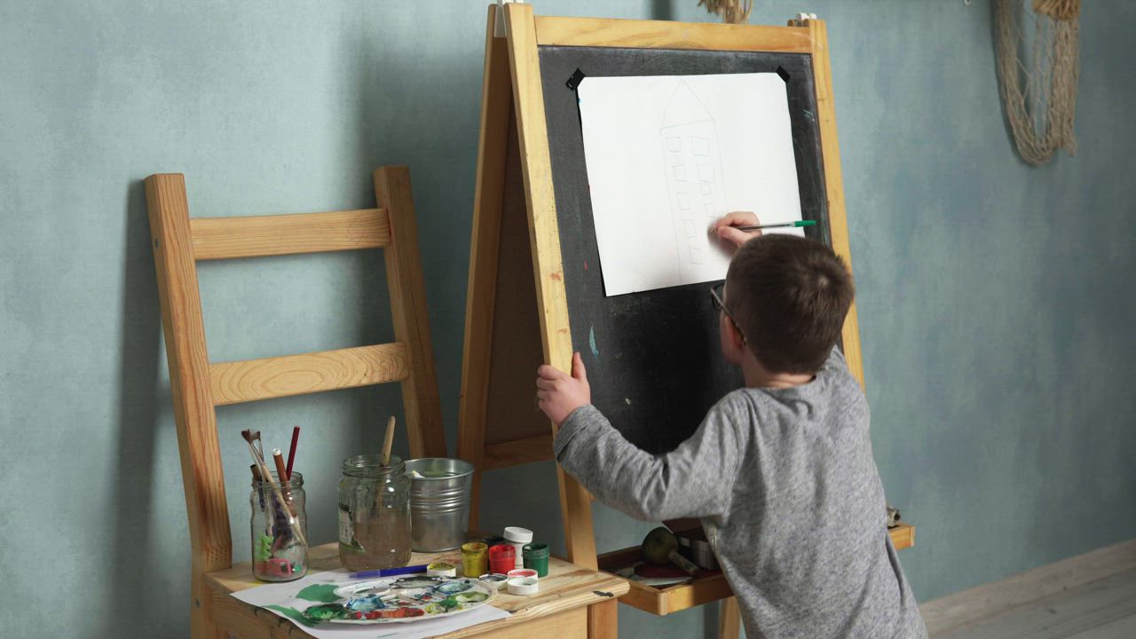 Young boy drawing a house - Free Stock Video