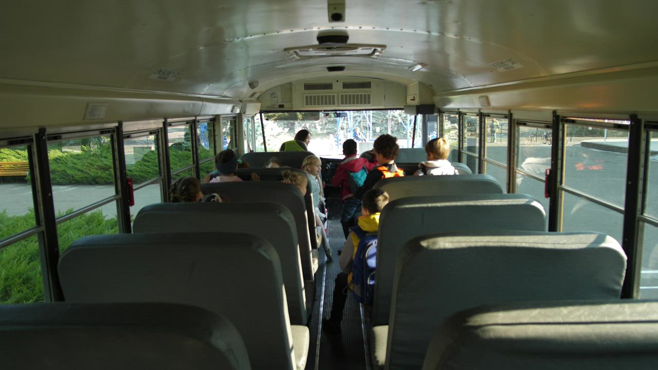 Children walking off of the bus - Free Stock Video