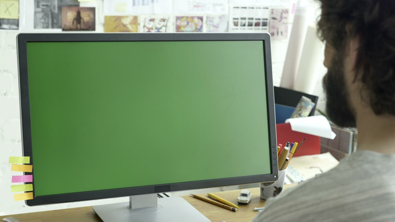 Man working on a computer with a green screen - Free Stock Video