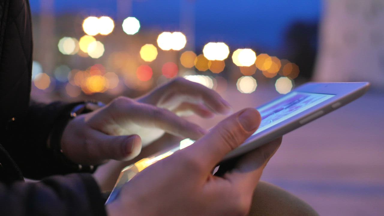 Woman using a tablet on the street - Free Stock Video