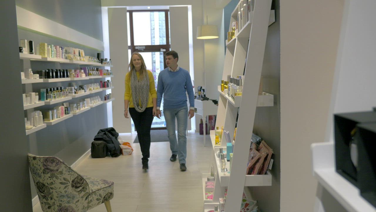 Smelling perfumes in a town shop - Free Stock Video