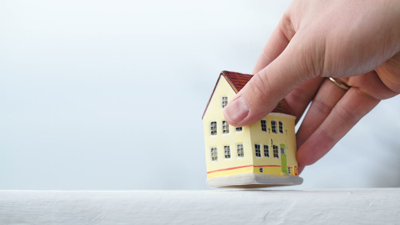 Placing down a toy house - Free Stock Video