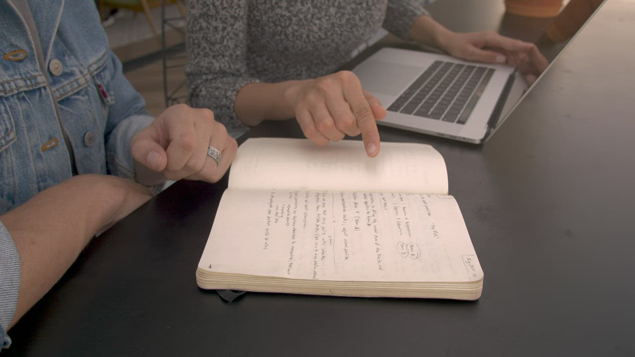 Two people working on a black table - Free Stock Video