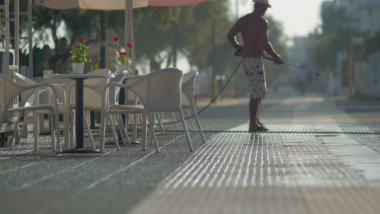 Cleaning the street outside a cafe - Free Stock Video