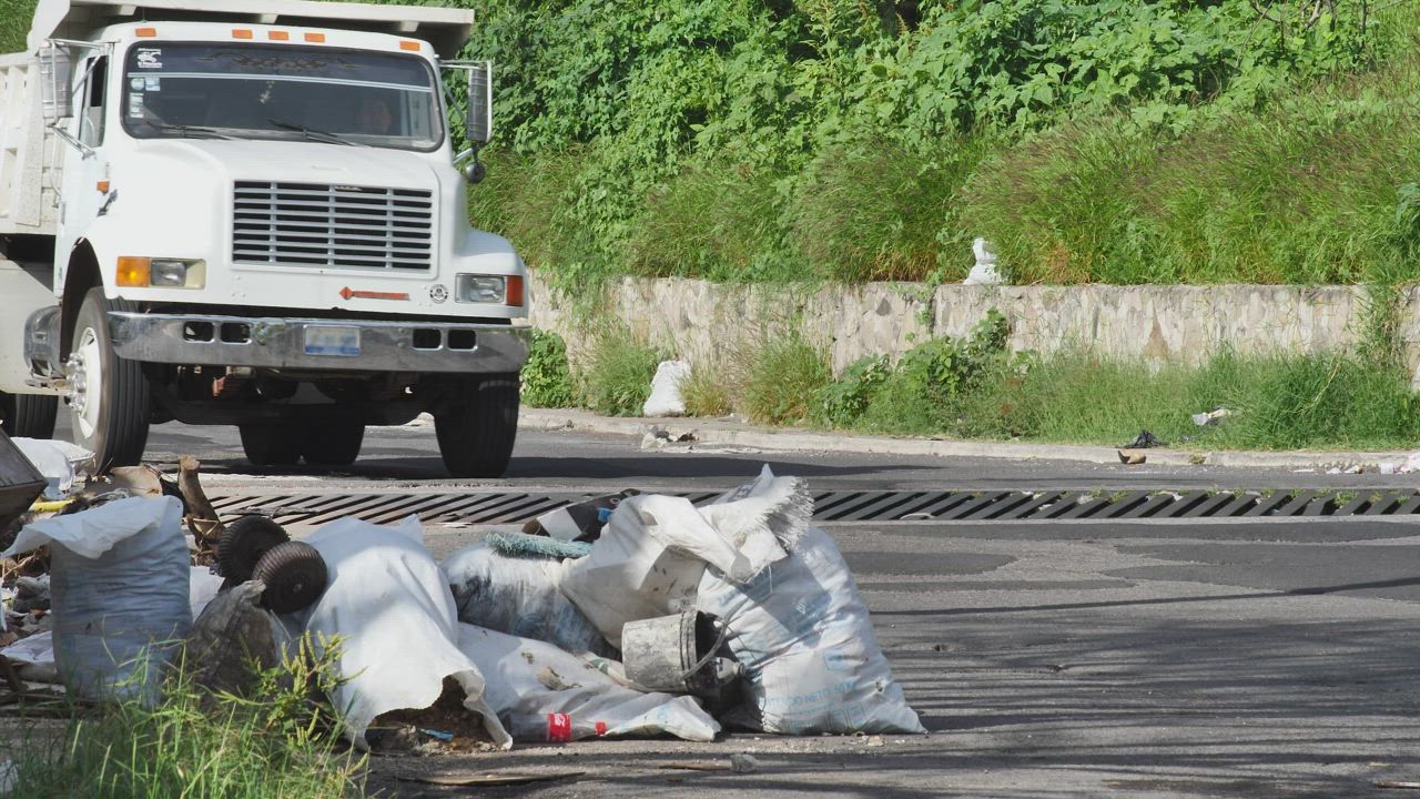 Rubbish piled up on a street sidewalk - Free Stock Video