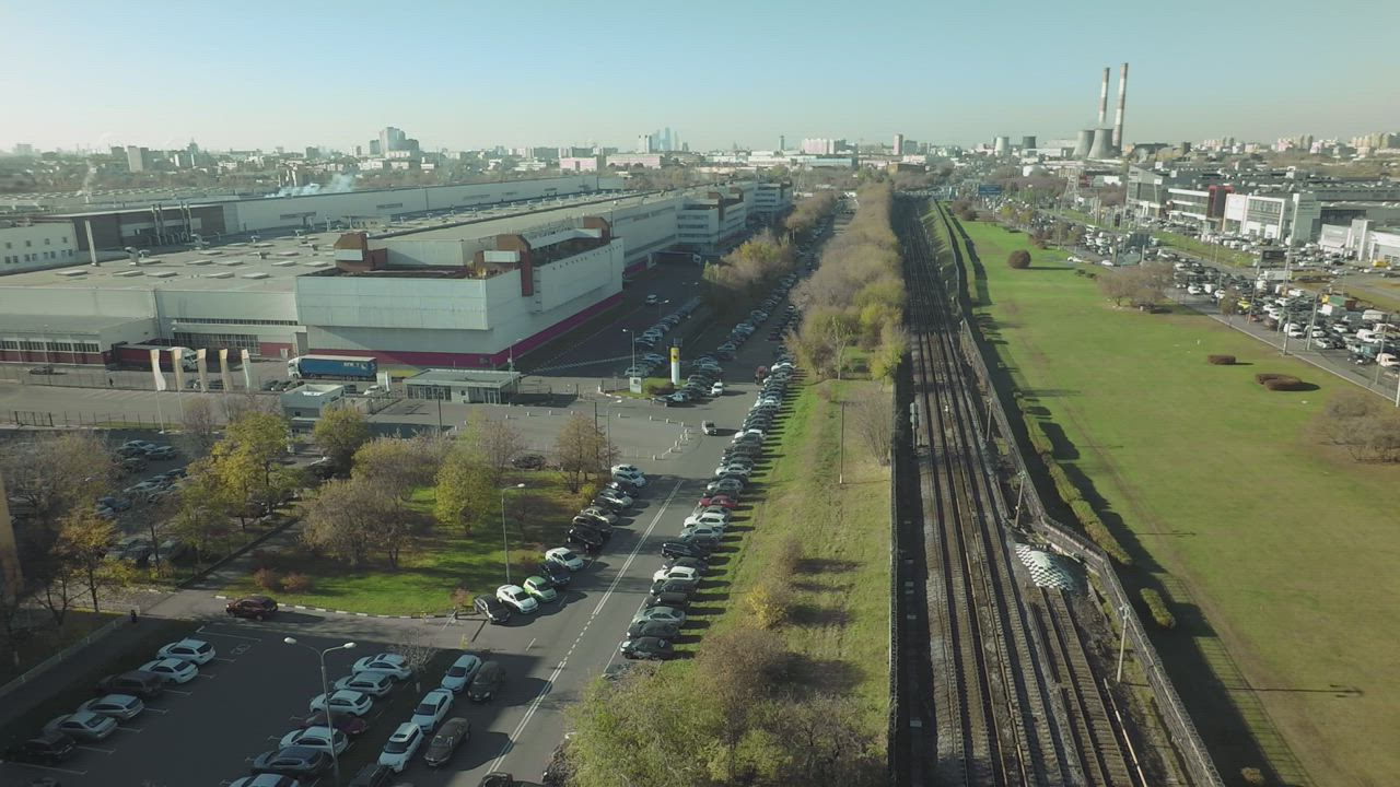 Train heading through an industrial city - Free Stock Video