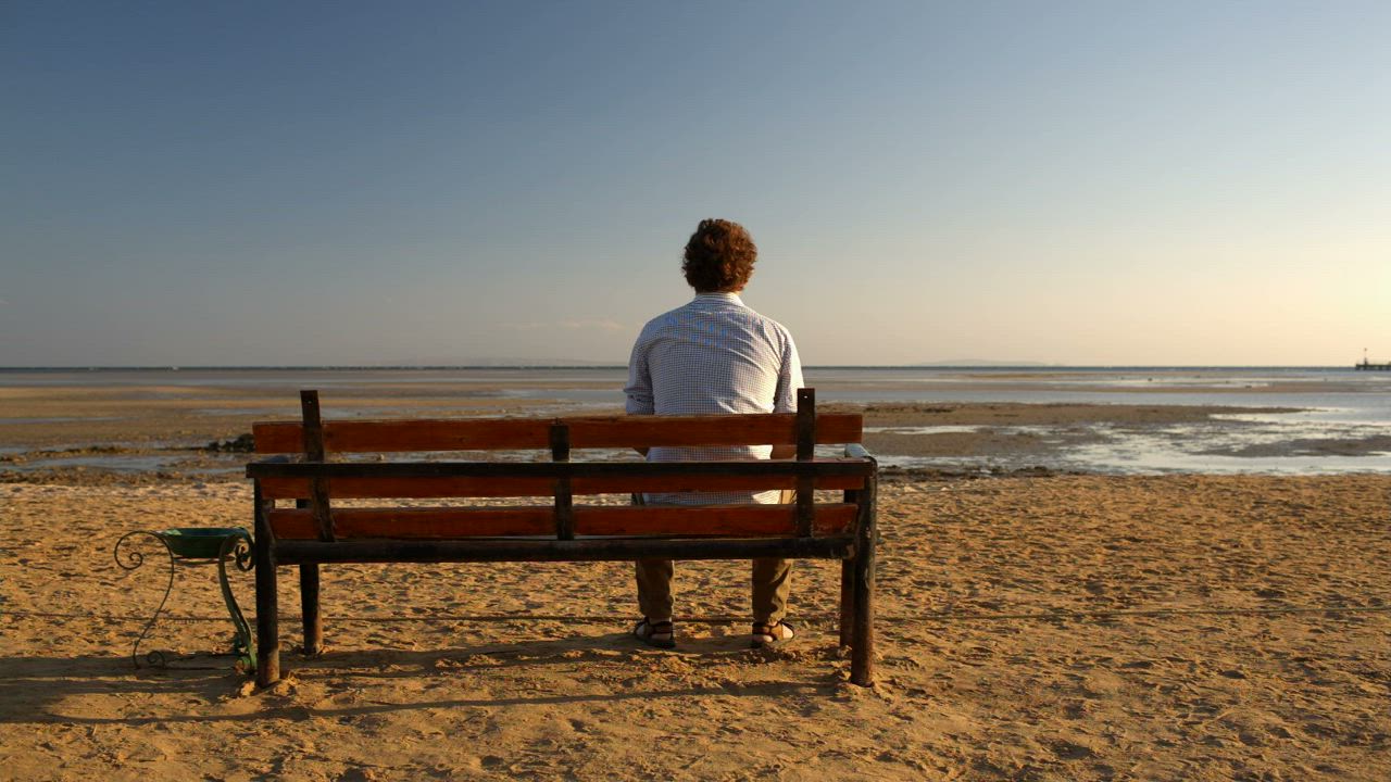Man sitting alone on a bench - Free Stock Video