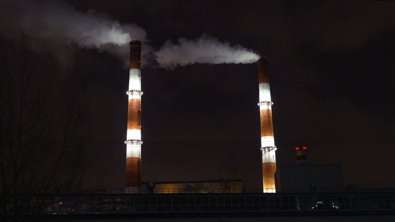 Smoke coming from a factory at night - Free Stock Video