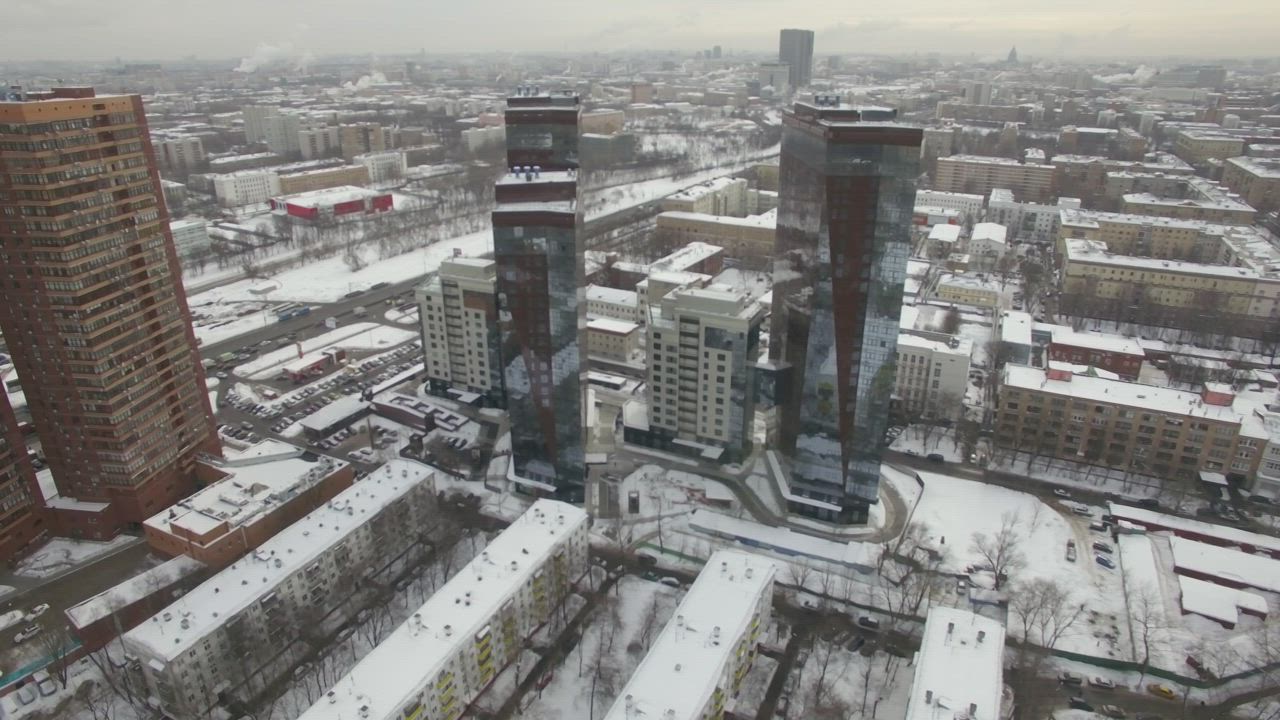 Snow covered buildings in an urban city - Free Stock Video