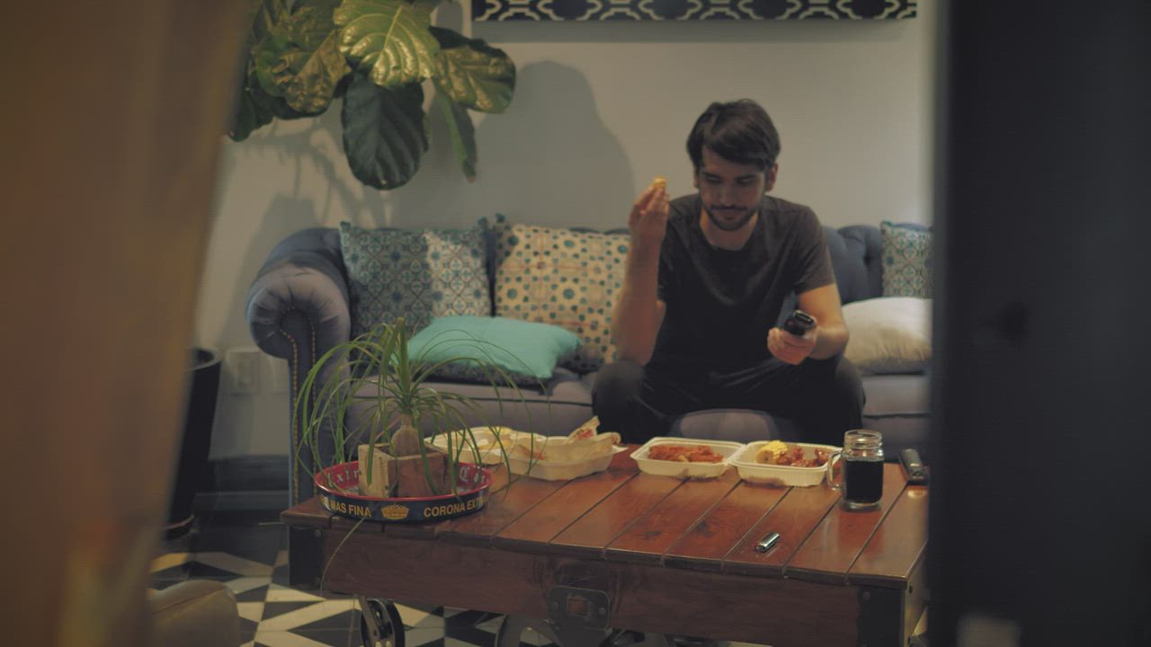 Eating fast food while watching TV - Free Stock Video